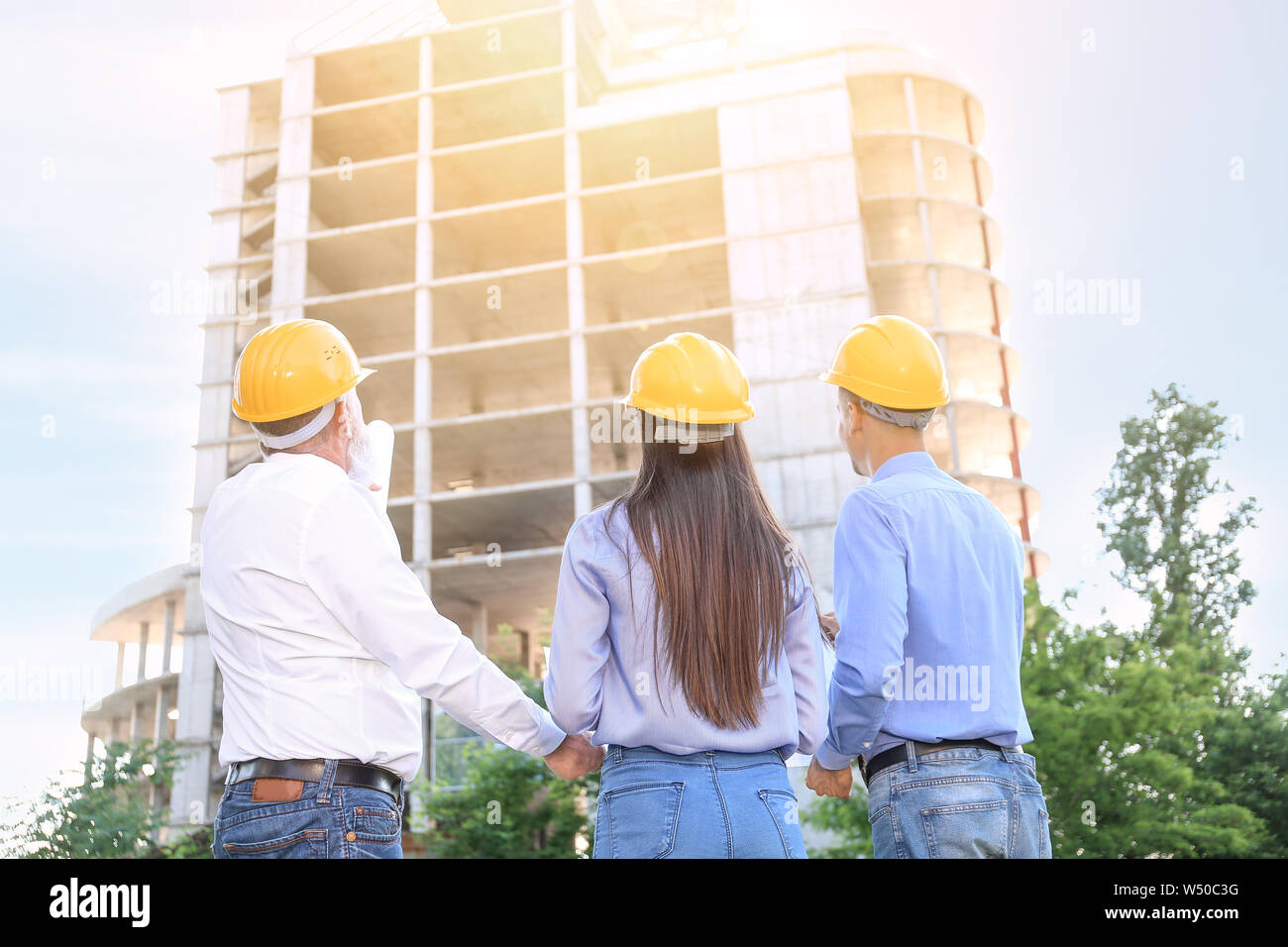 Architects discussing project of building outdoors Stock Photo - Alamy