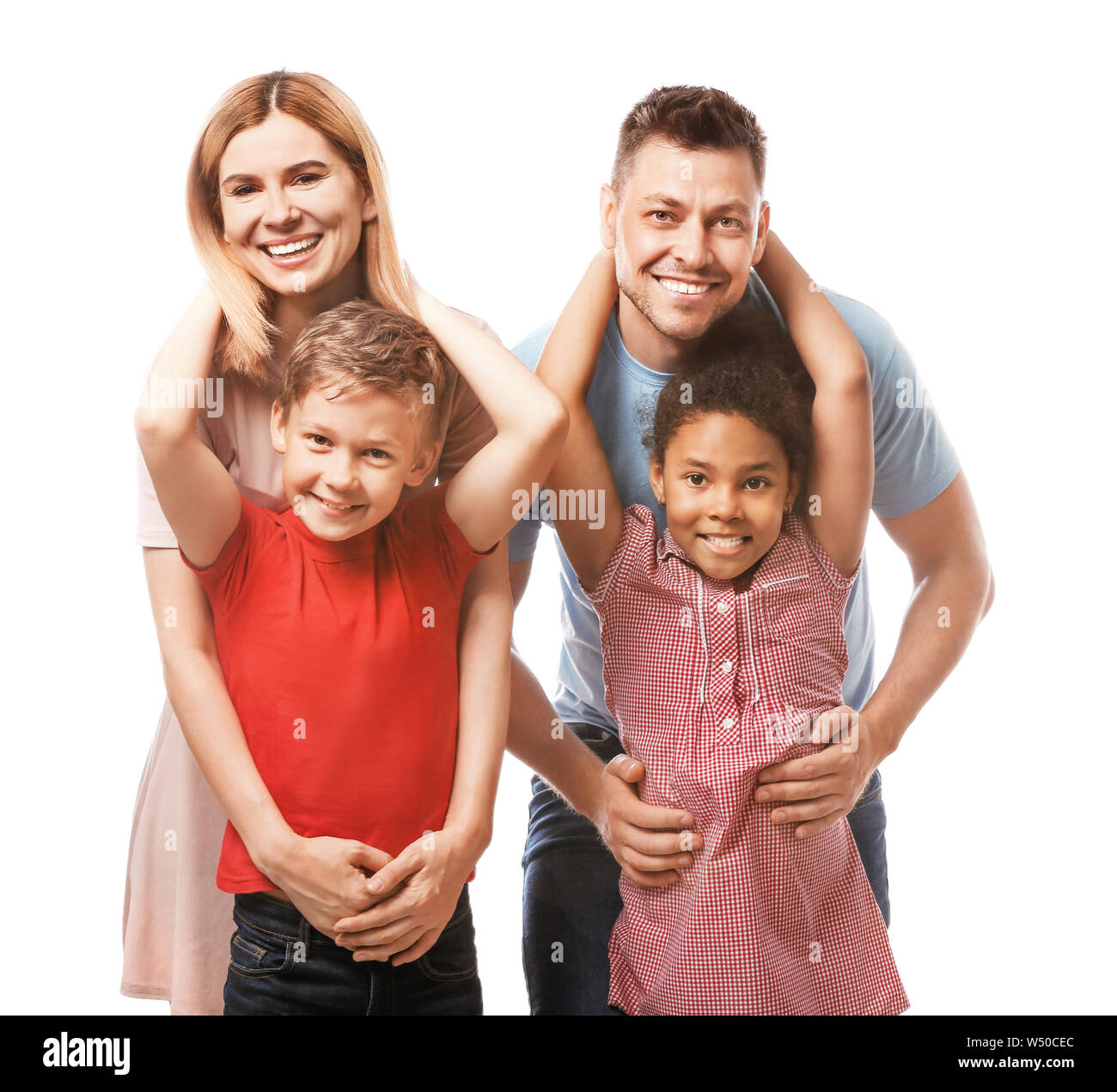 Happy couple with little adopted children on white background Stock ...