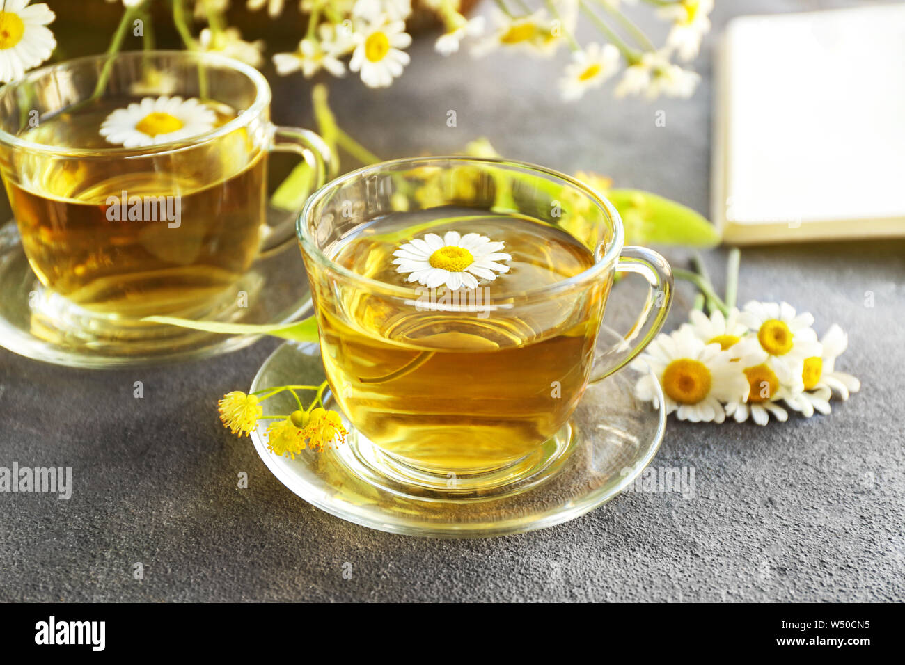 Cups of hot chamomile tea on grey table Stock Photo - Alamy