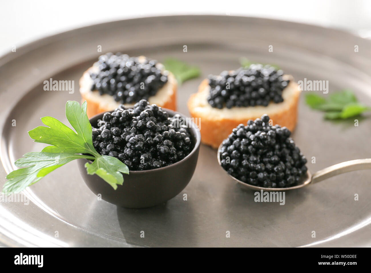 Delicious caviar and bread on tray, closeup Stock Photo - Alamy