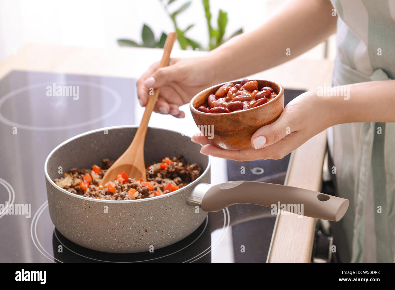 Woman cooking chili con carne hi-res stock photography and images - Alamy
