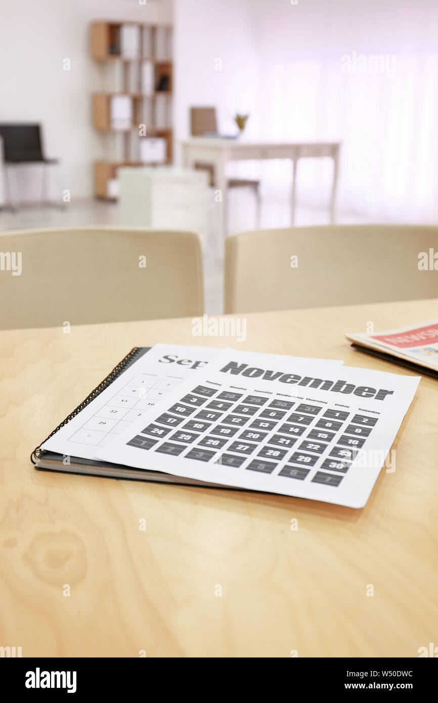 Paper sheet with calendar on office table Stock Photo - Alamy