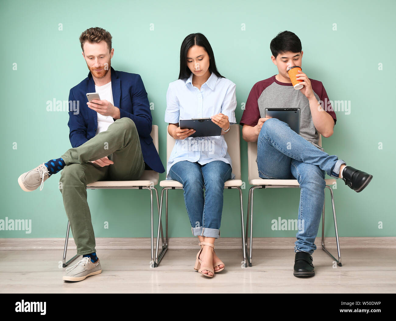 Young people waiting for job interview indoors Stock Photo - Alamy