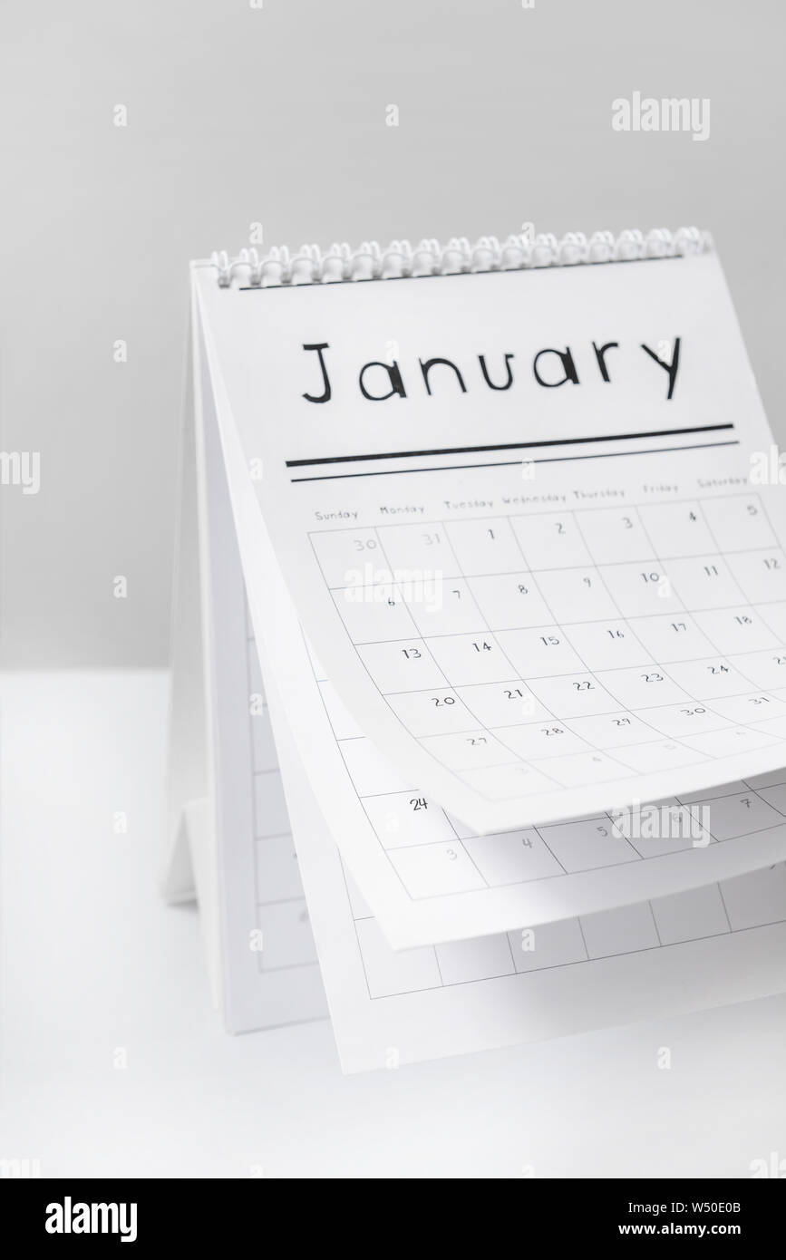 Flip calendar on table against light background Stock Photo - Alamy
