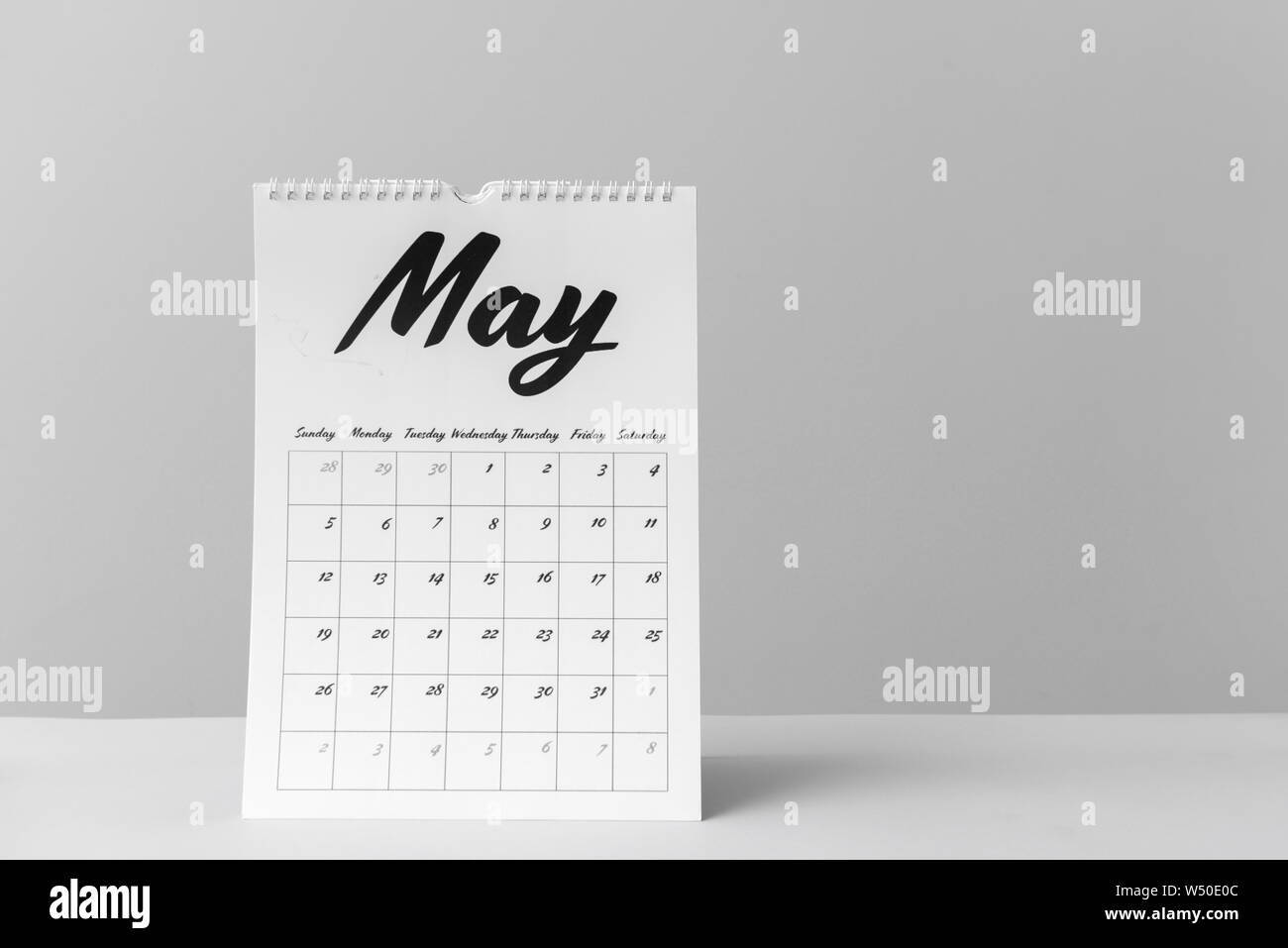 Flip calendar on table against light background Stock Photo - Alamy