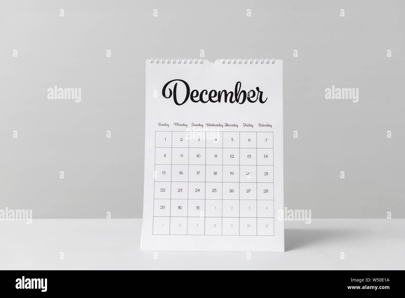 Flip calendar on table against light background Stock Photo - Alamy