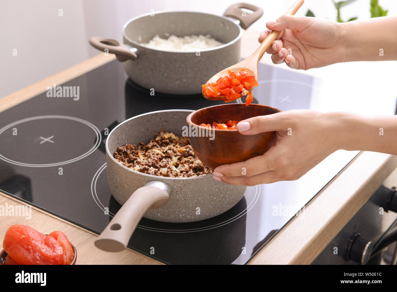 Woman cooking traditional chili con carne in kitchen Stock Photo - Alamy