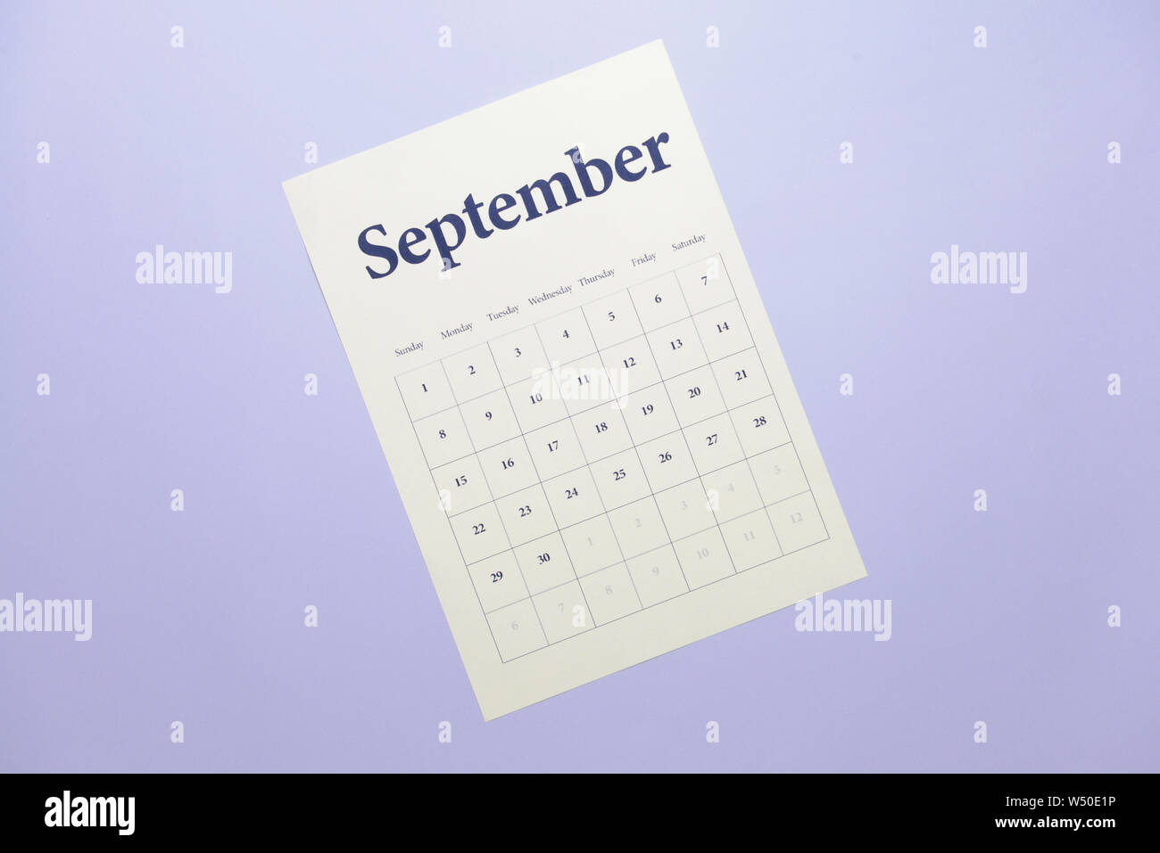 Sheet of paper calendar on color background Stock Photo - Alamy