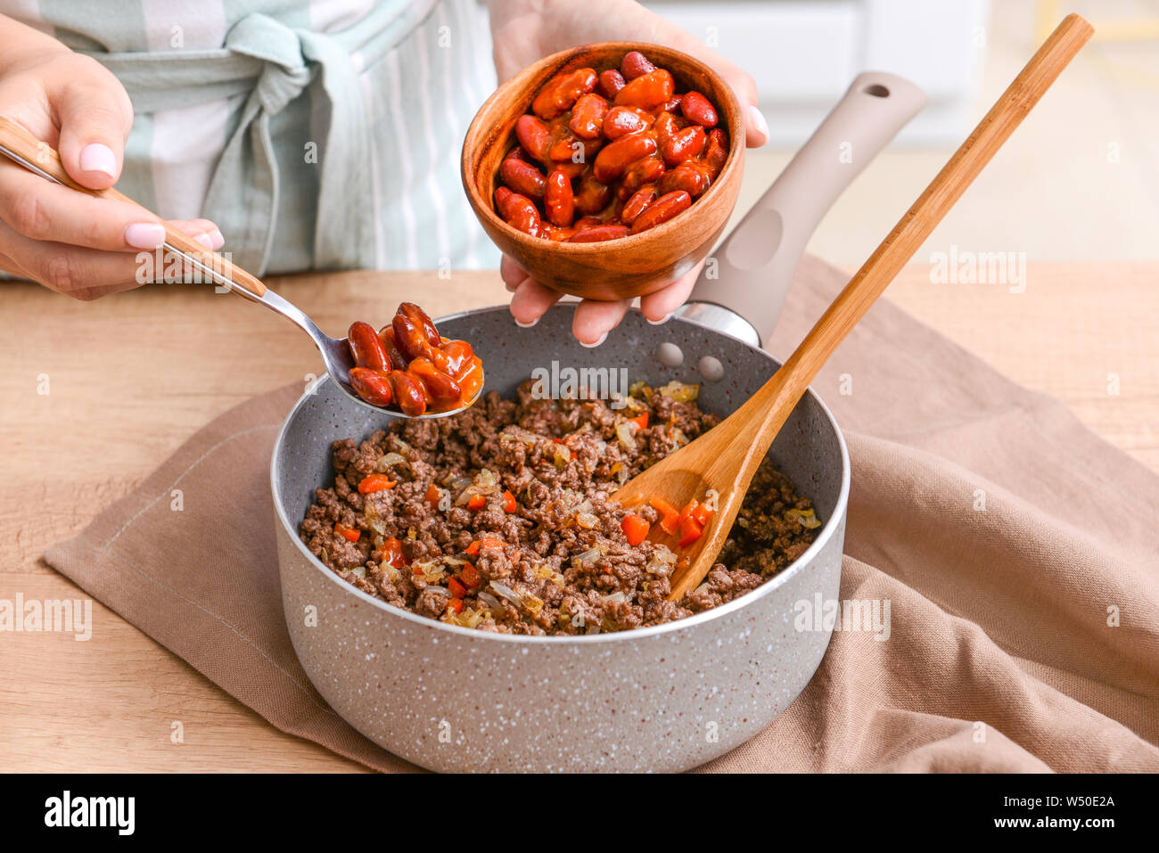 Woman cooking traditional chili con carne in kitchen, closeup Stock ...