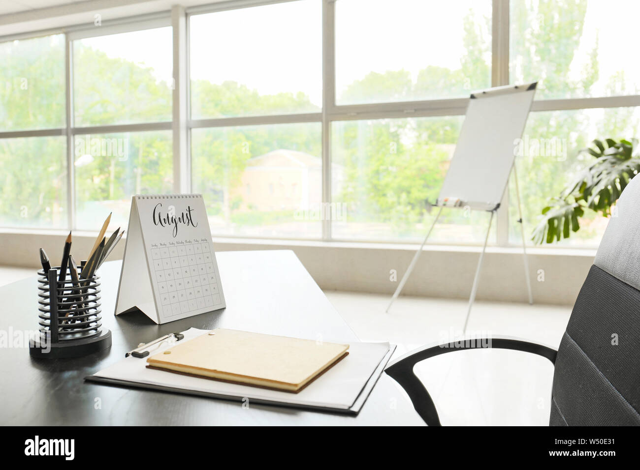 Flip paper calendar and stationery on office table Stock Photo - Alamy