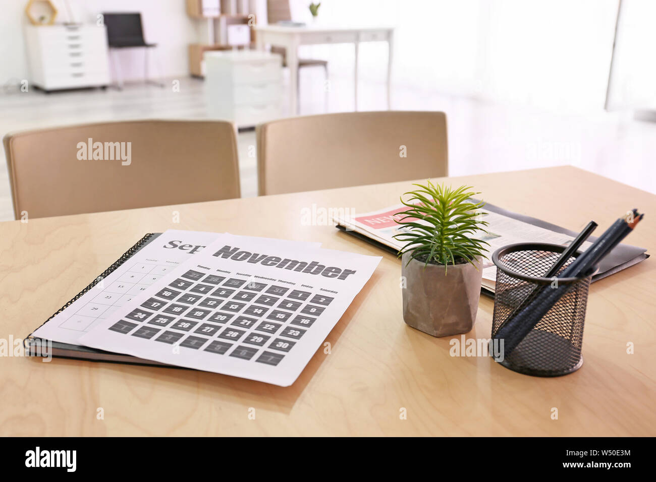 Paper sheet with calendar on office table Stock Photo - Alamy