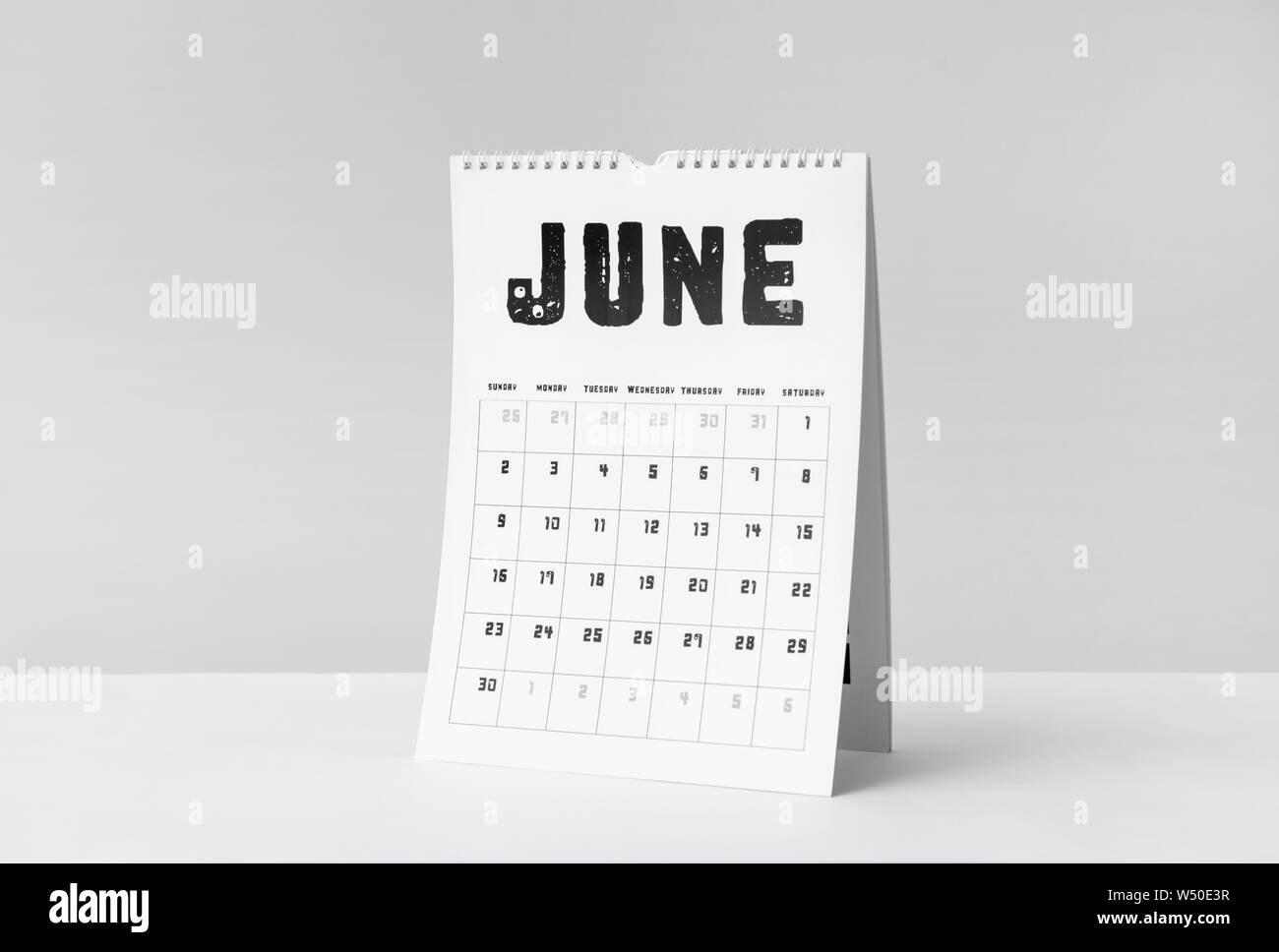 Flip calendar on table against light background Stock Photo - Alamy