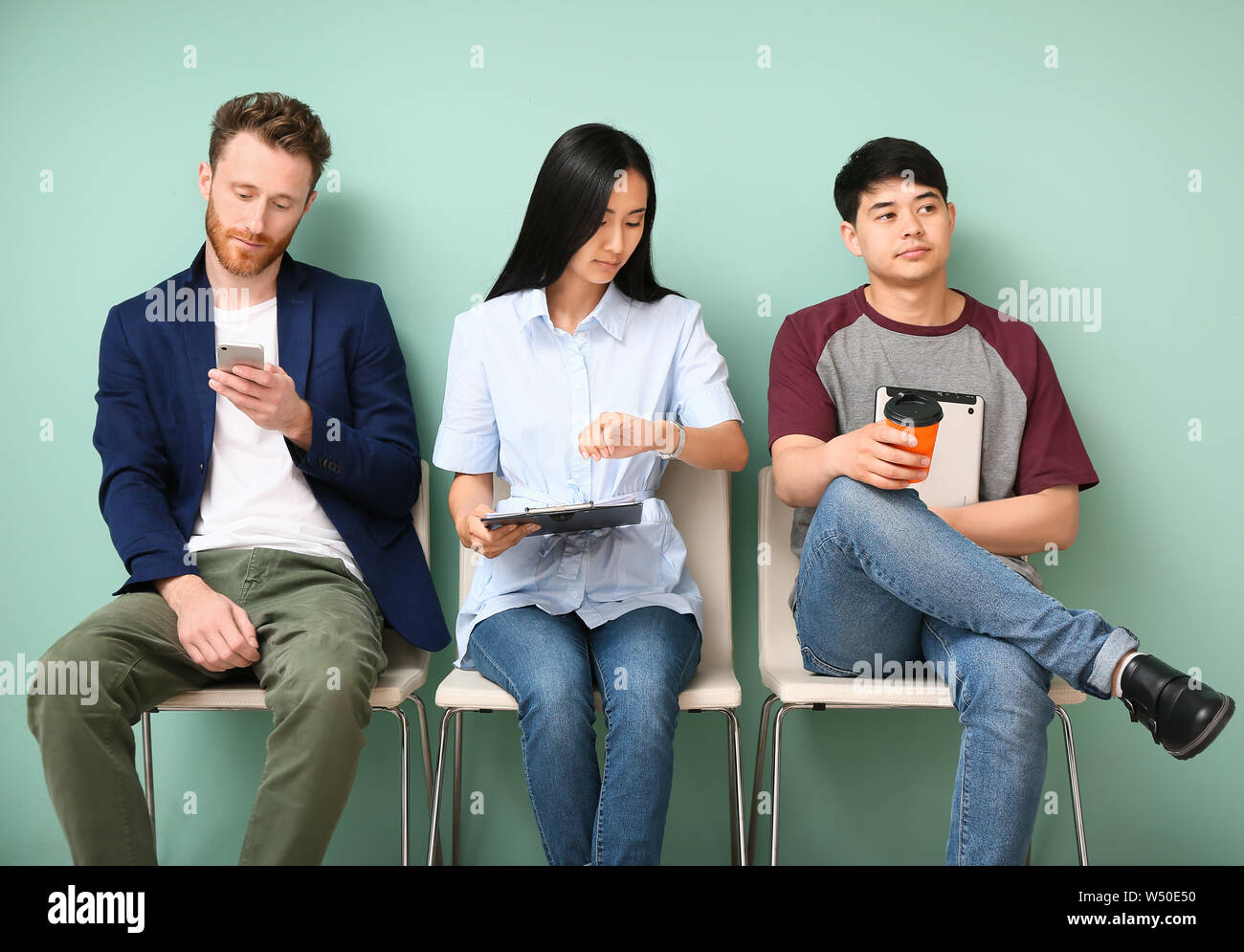 Young people waiting for job interview indoors Stock Photo - Alamy