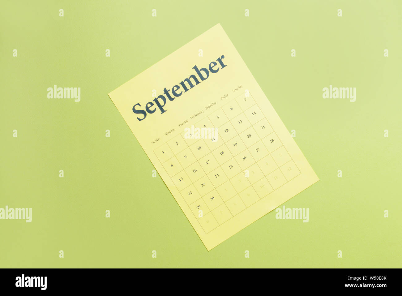 Sheet of paper calendar on color background Stock Photo - Alamy