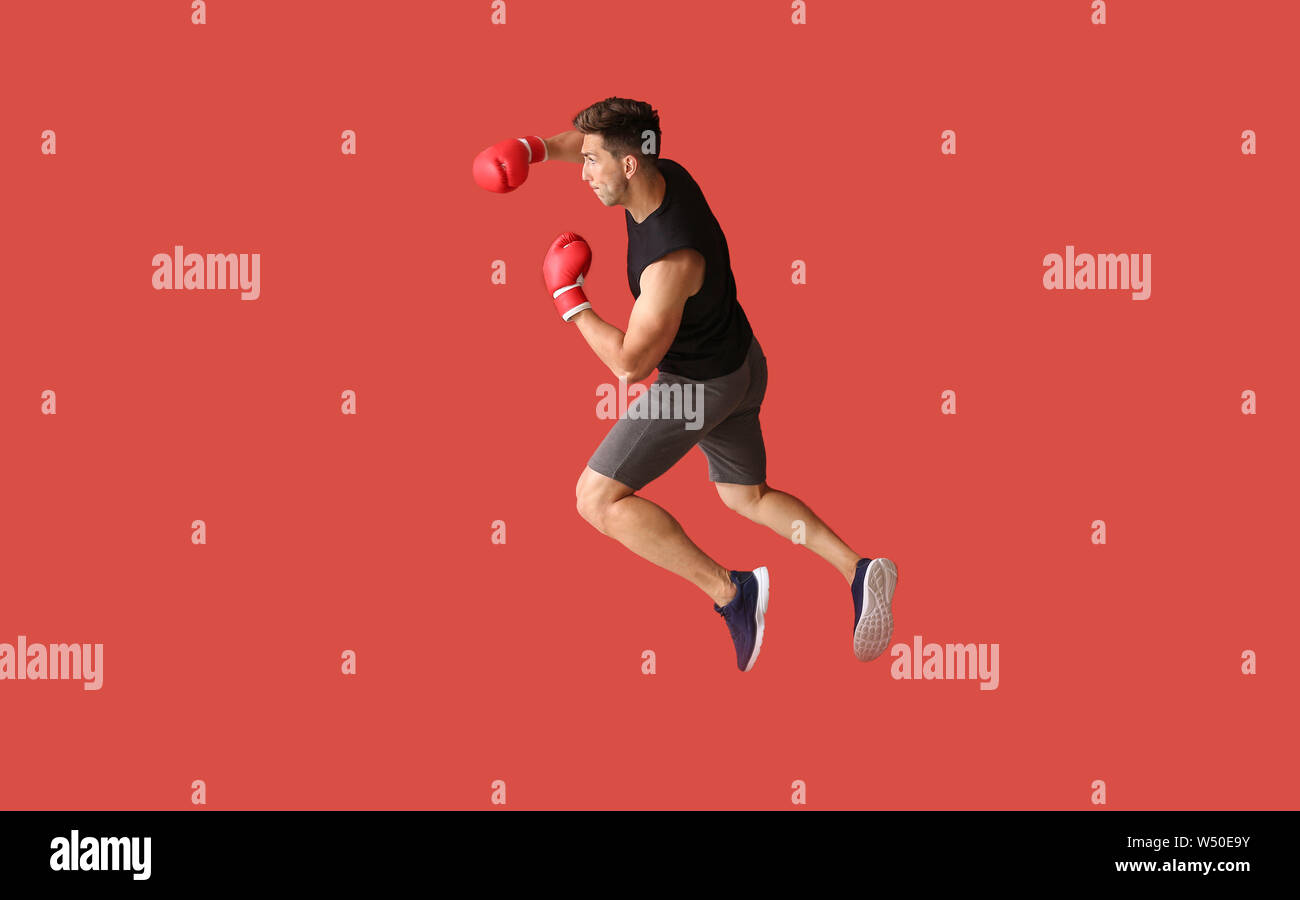 Sporty male boxer on color background Stock Photo - Alamy
