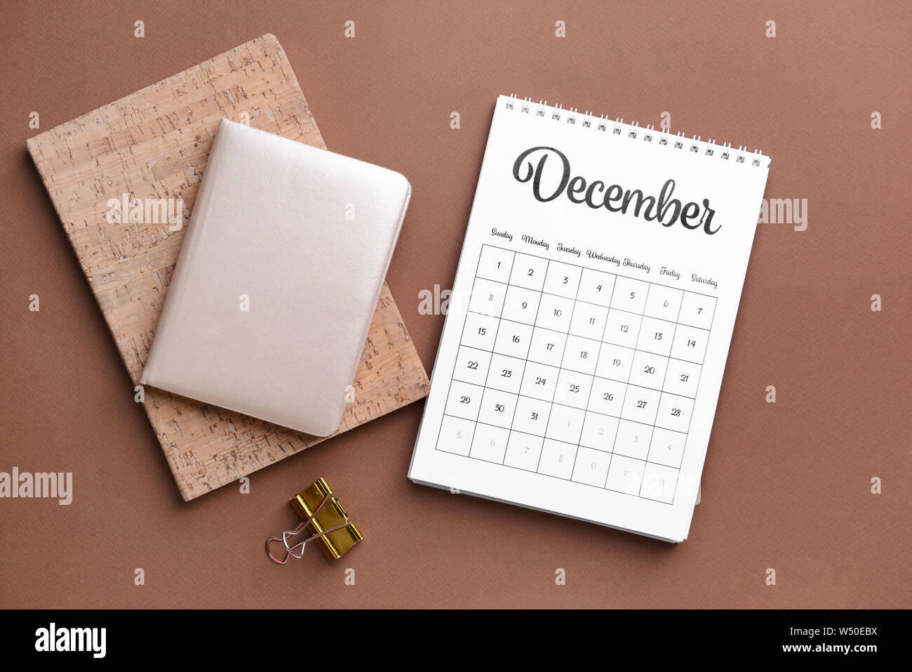 Flip paper calendar and notebooks on color background Stock Photo - Alamy