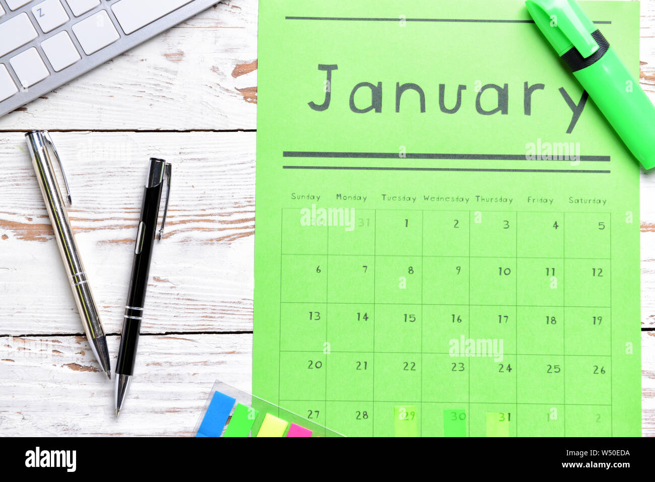 Paper calendar and pens on wooden background Stock Photo - Alamy