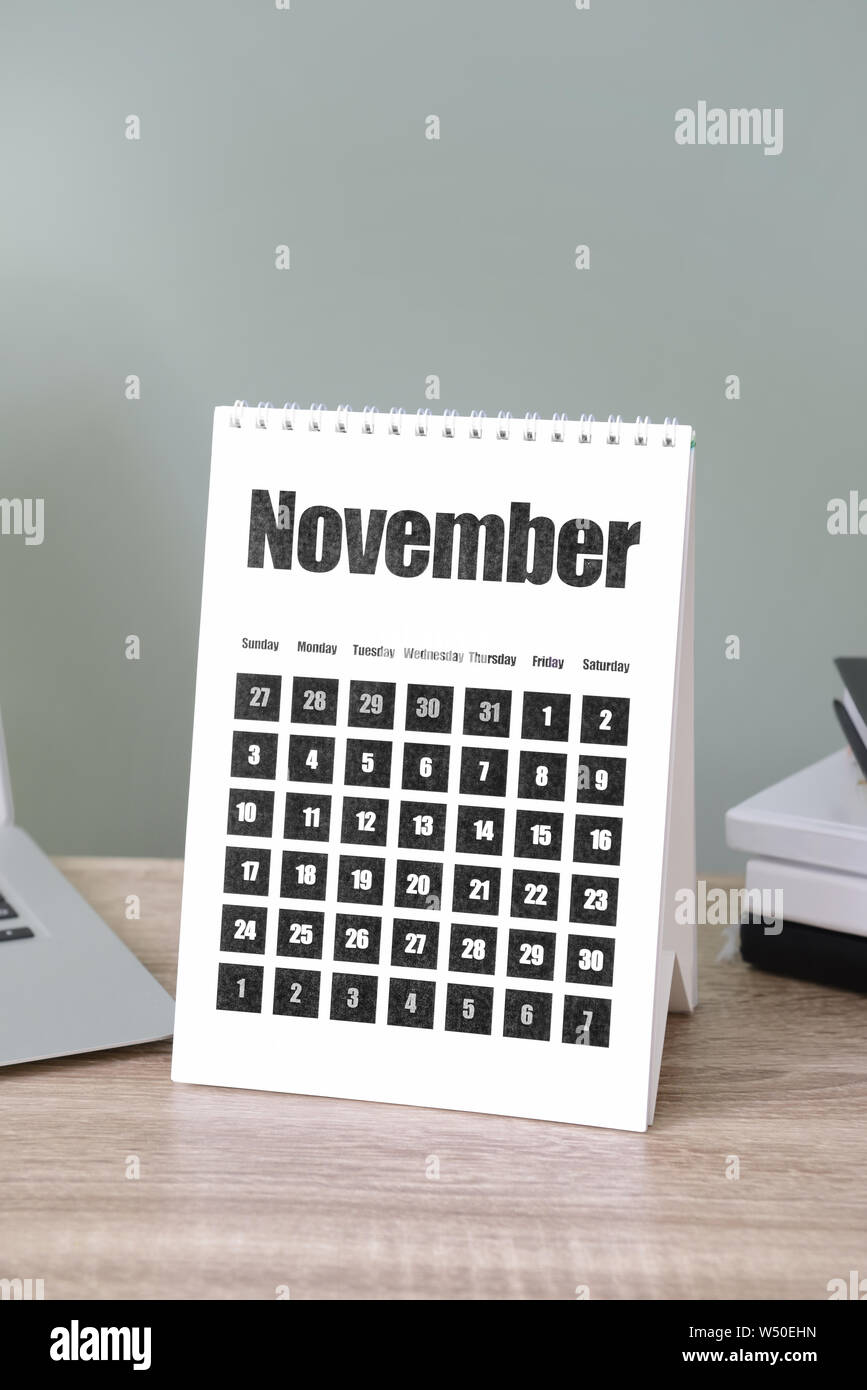 Calendar on table in office Stock Photo - Alamy