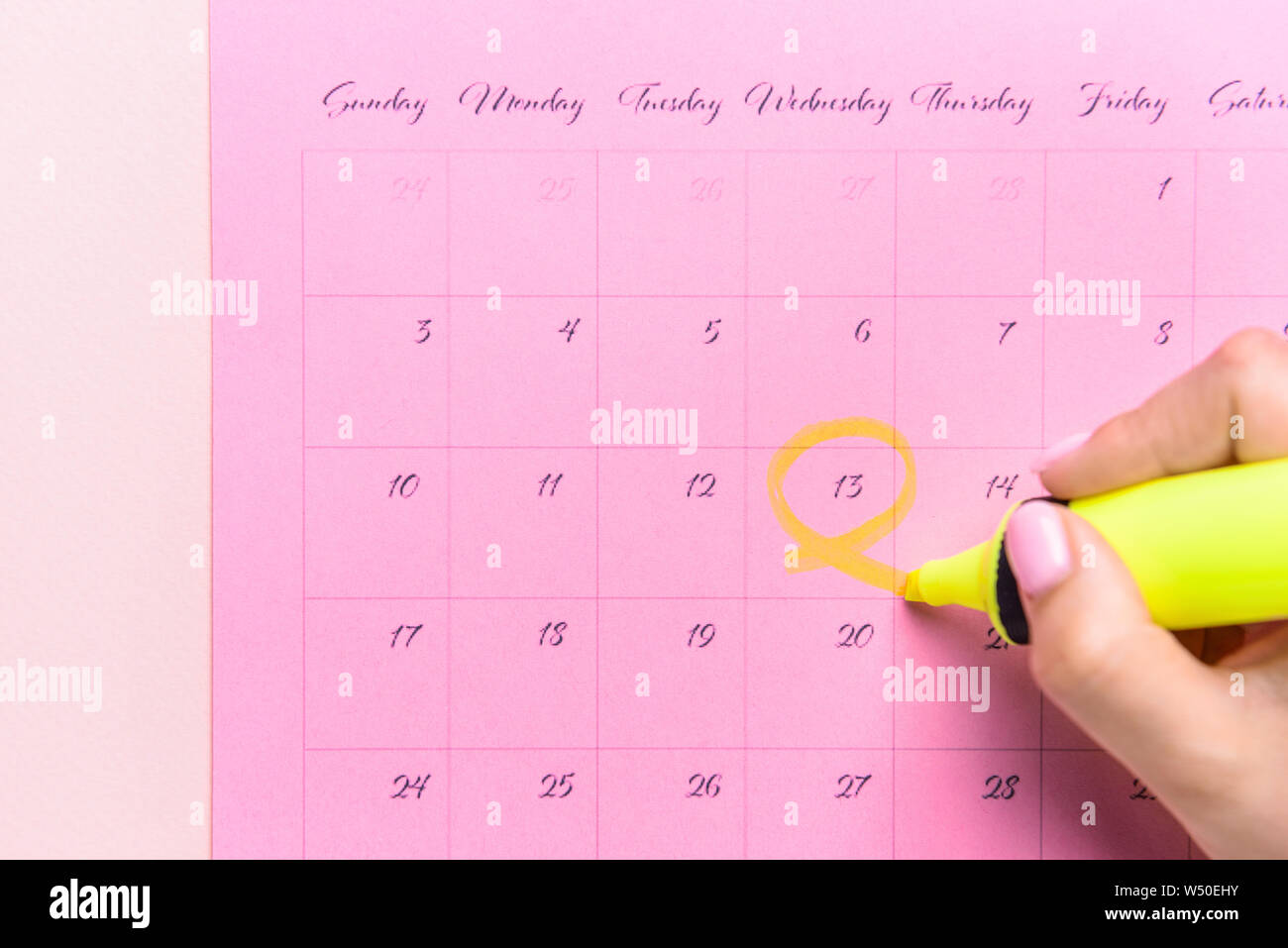 Woman marking date in calendar, closeup Stock Photo - Alamy