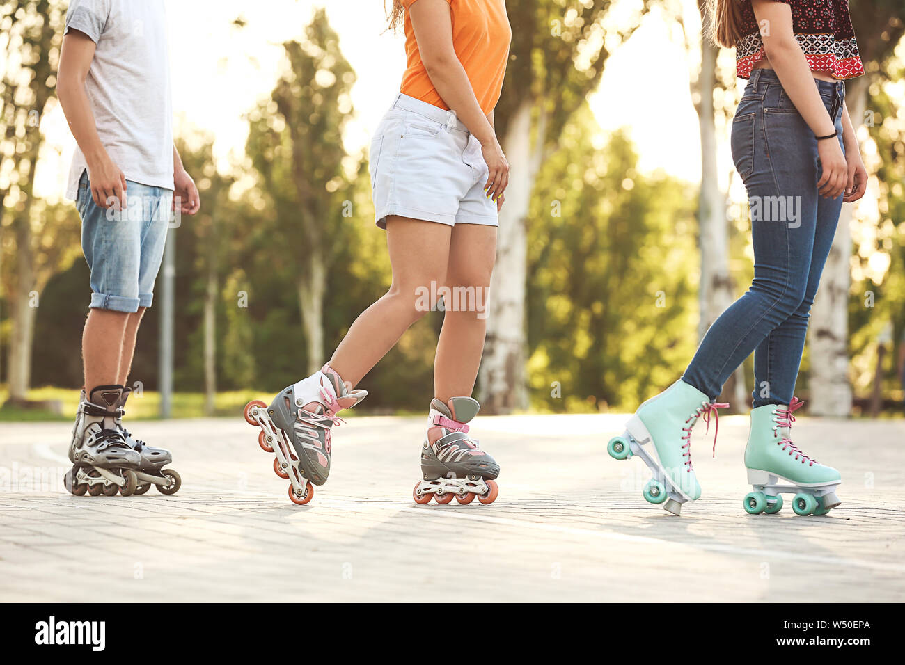 Teenagers on roller skates outdoors Stock Photo - Alamy