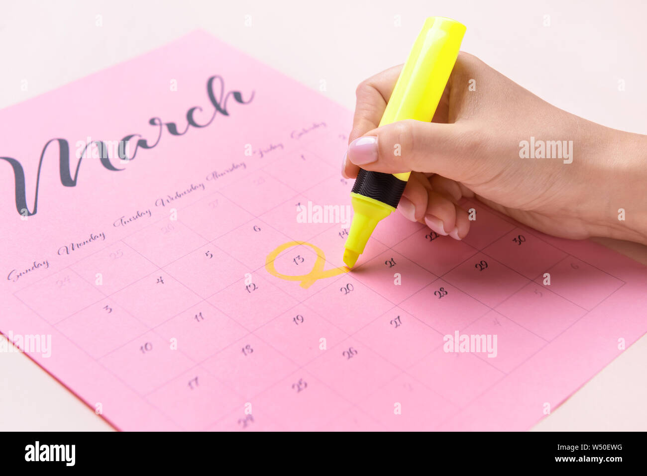Woman marking date in calendar, closeup Stock Photo - Alamy