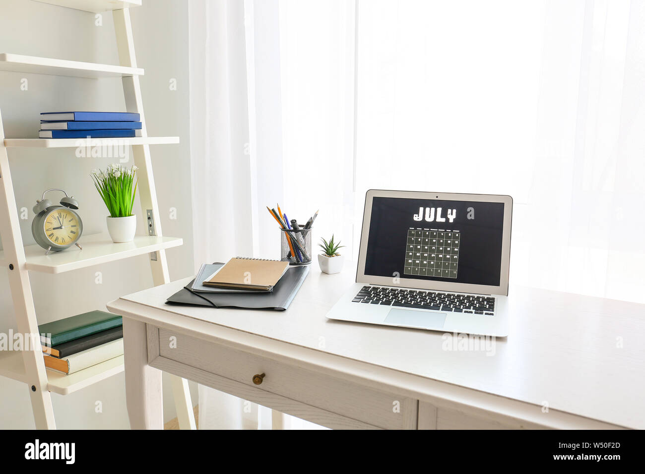 Calendar on screen of laptop in room Stock Photo - Alamy