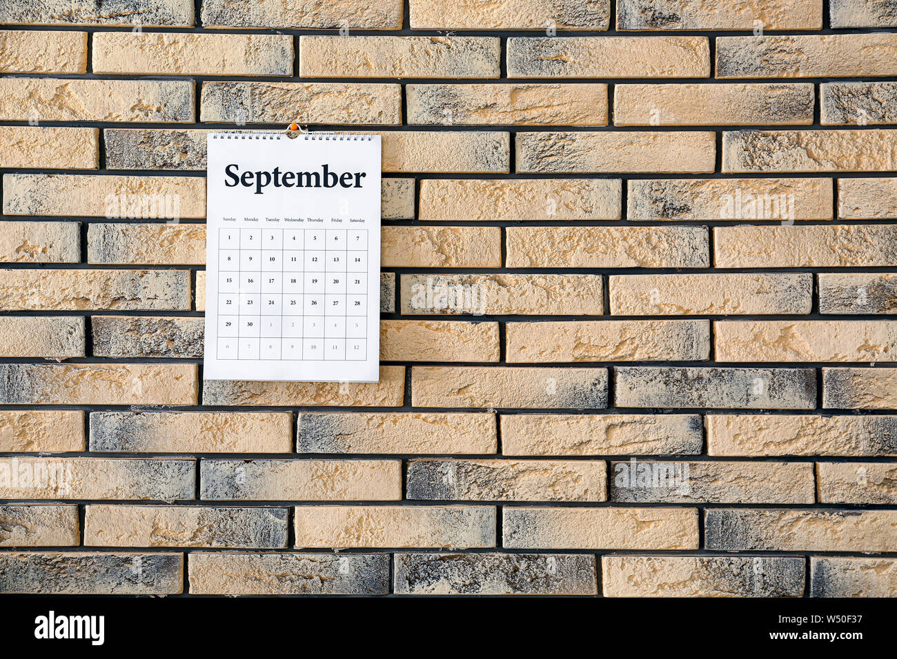 Flip calendar hanging on wall Stock Photo - Alamy
