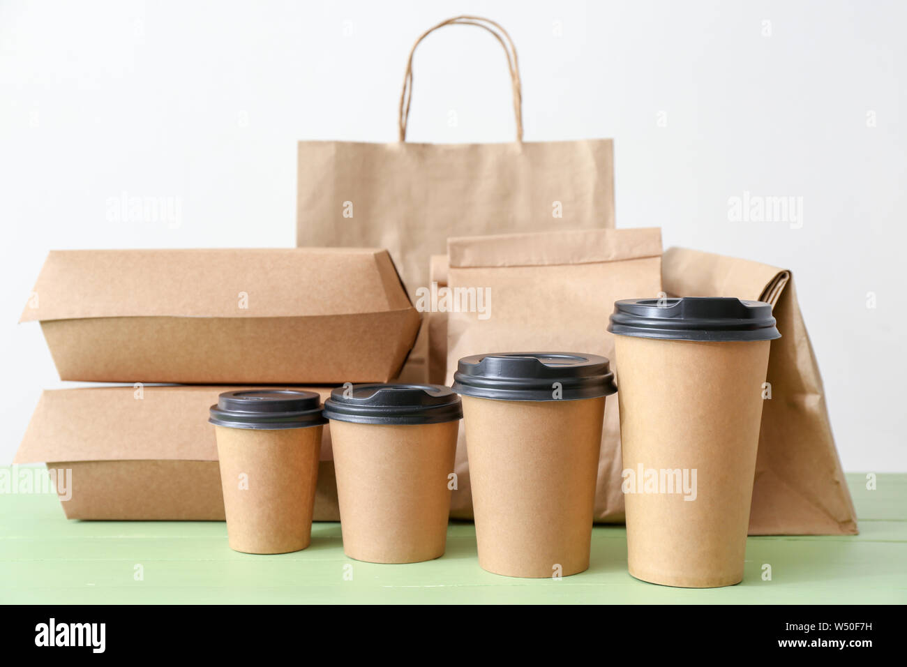 Assortment of food delivery containers on table Stock Photo - Alamy