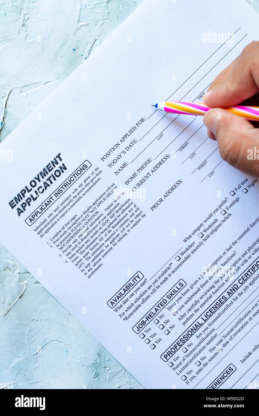 Hand filling Standard Application for Employment. HR, Hiring, Applicant ...