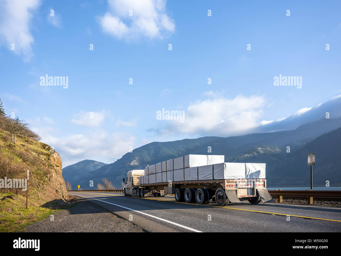 Big rig classic American powerful white semi truck with flat bed semi ...