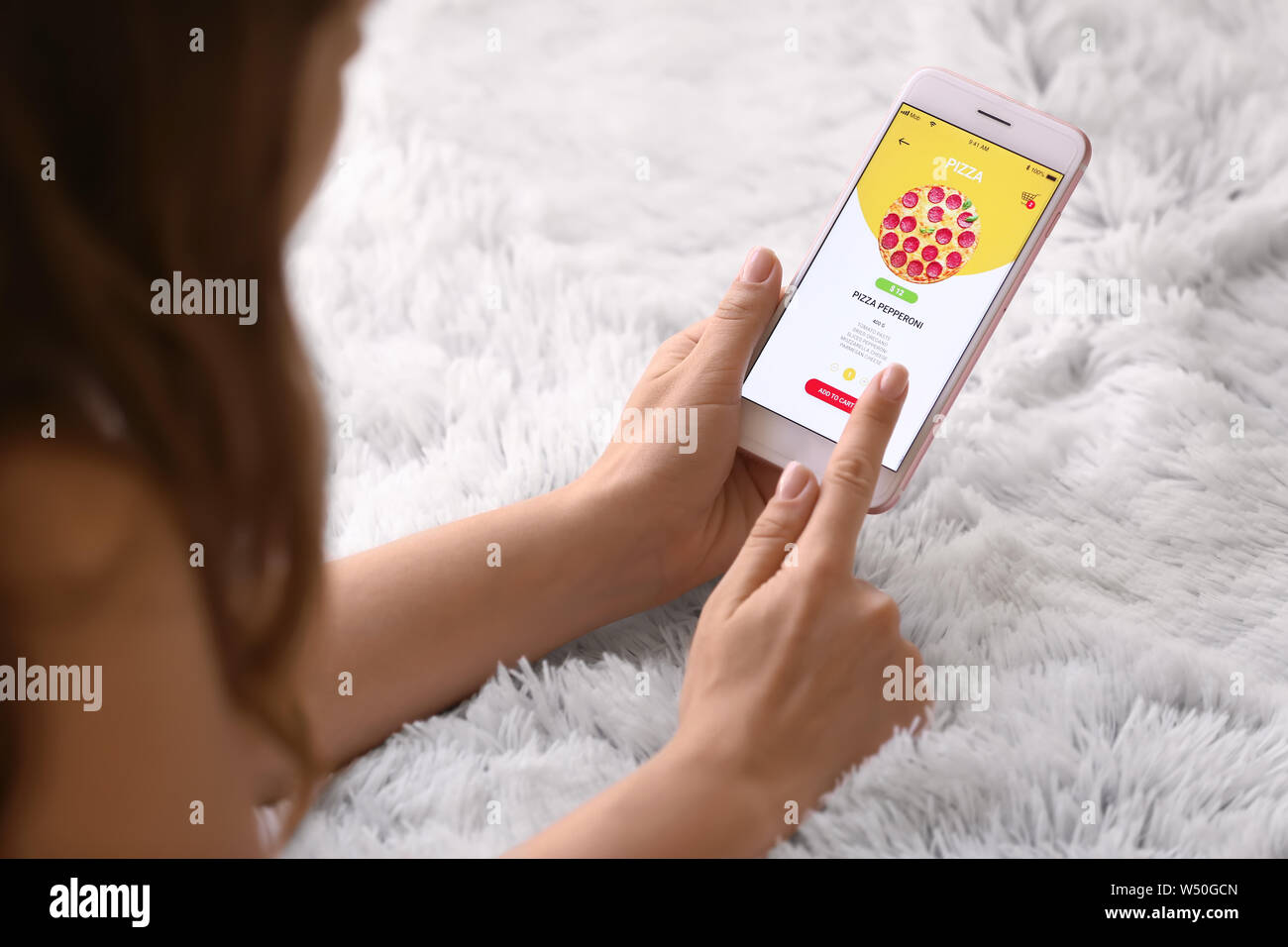 Woman with mobile phone ordering food online Stock Photo - Alamy