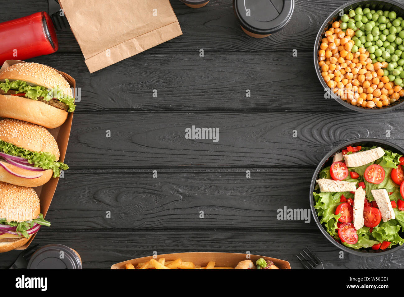 Different tasty food from delivery service on wooden background Stock ...