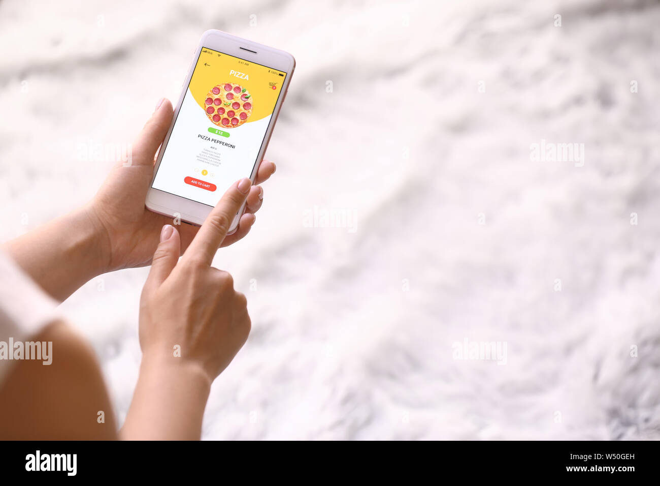 Woman with mobile phone ordering food online Stock Photo - Alamy