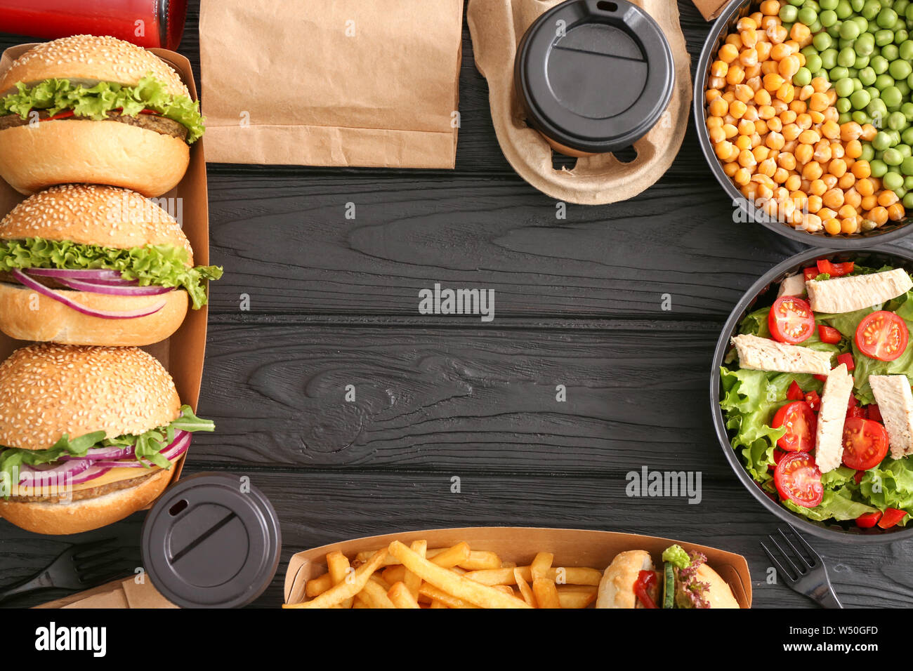 Different tasty food from delivery service on wooden background Stock ...