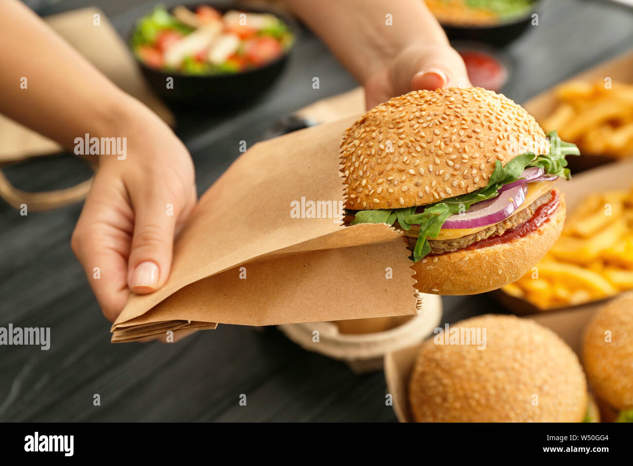 Worker of food delivery service packing order for customer, closeup ...