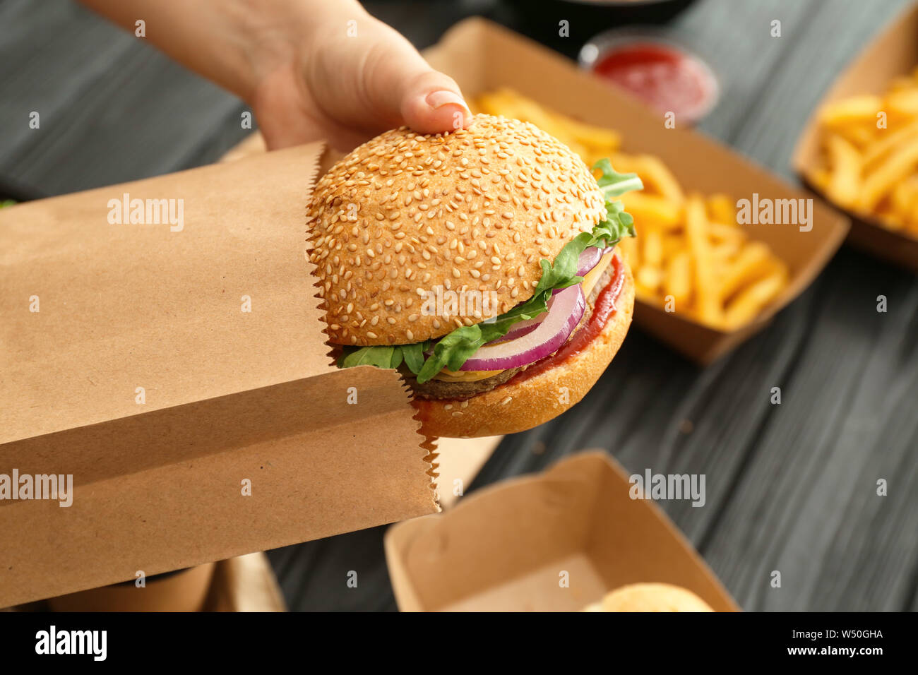 Worker of food delivery service packing order for customer, closeup ...
