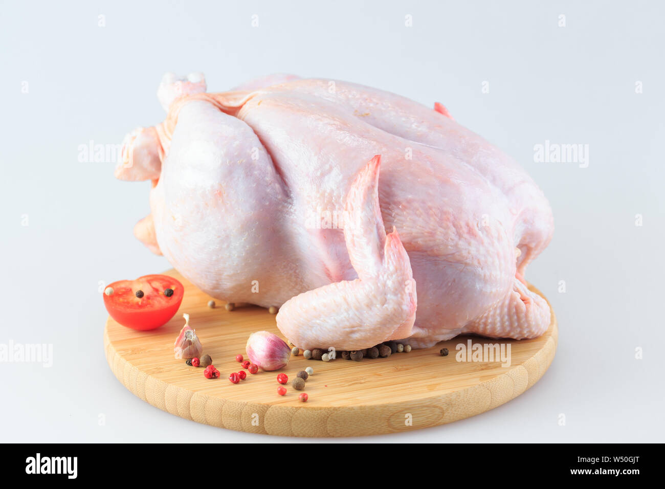 raw chicken carcass on the cutting board isolated on white background ...