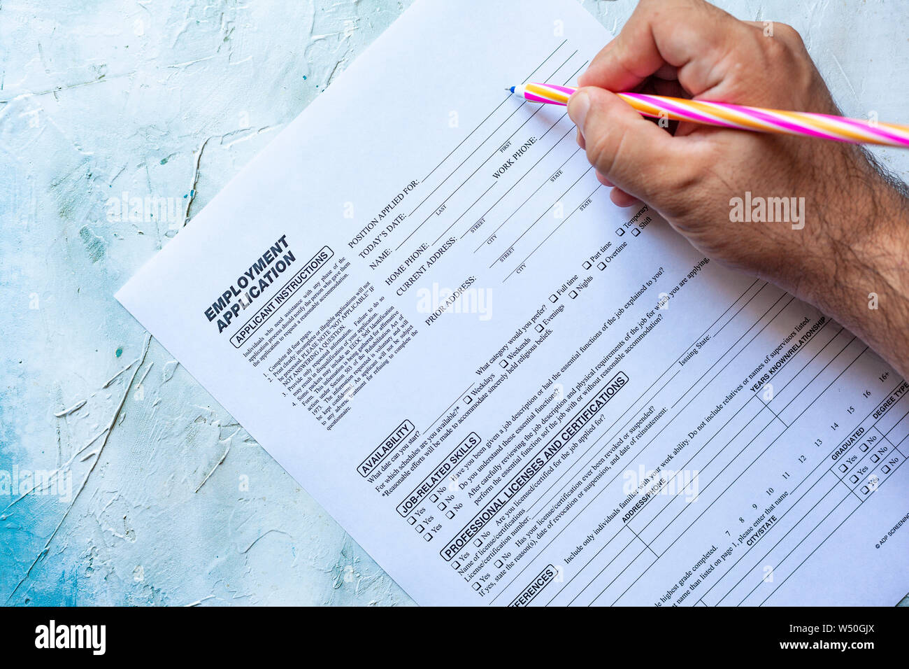 Hand filling Standard Application for Employment. HR, Hiring, Applicant ...