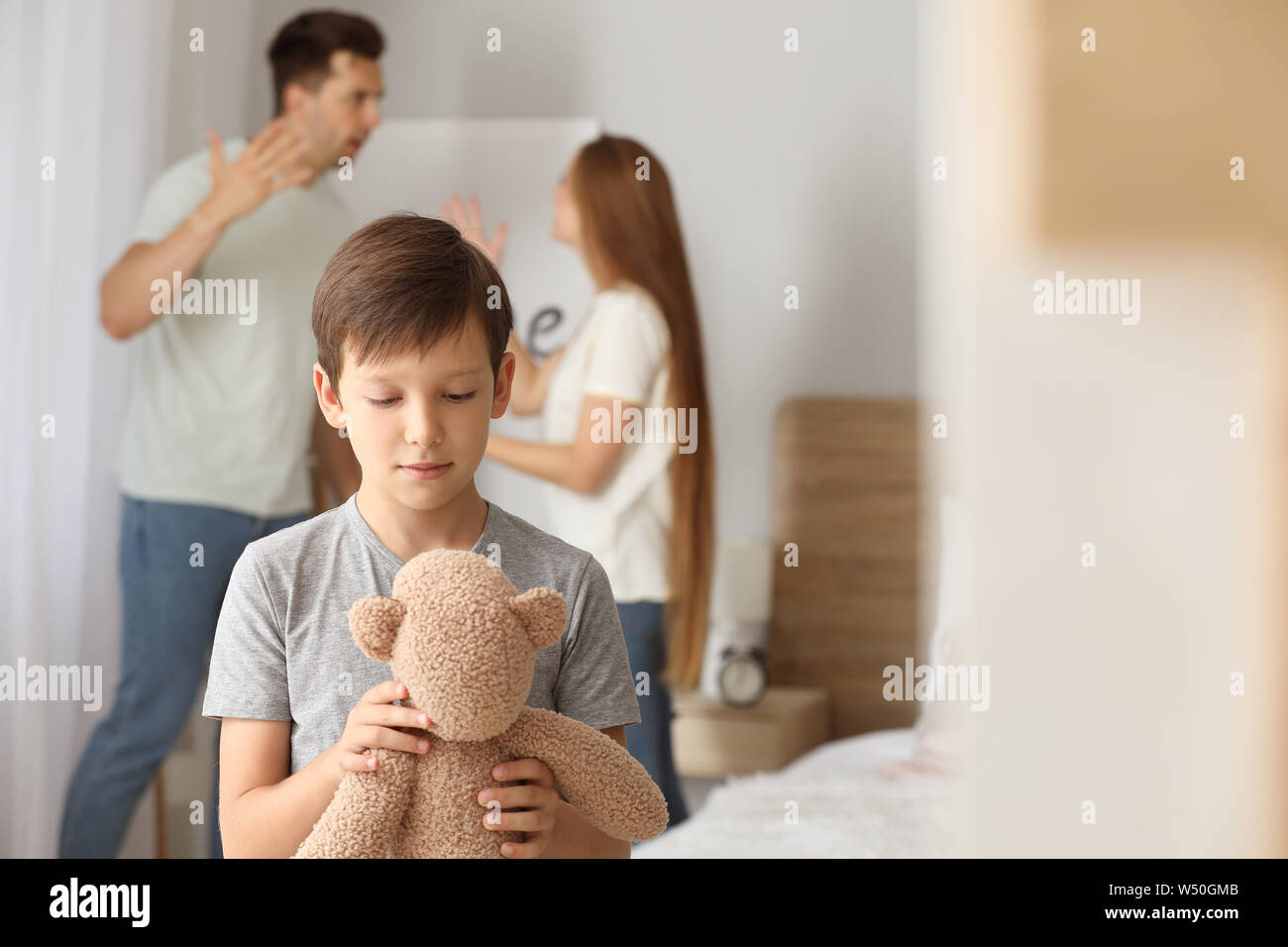 Sad little boy and his quarreling parents at home Stock Photo - Alamy