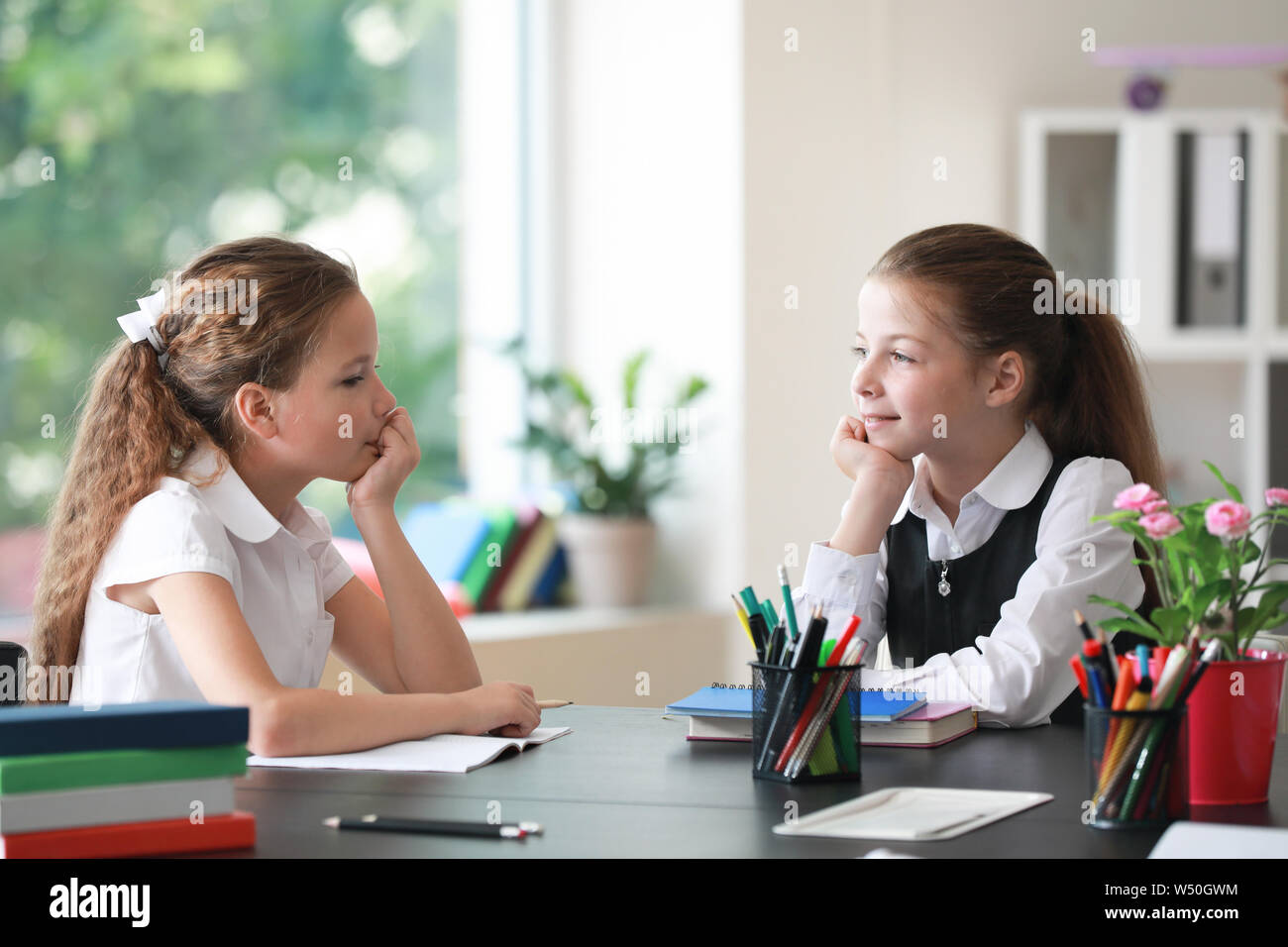 Cute little children doing lessons in classroom Stock Photo - Alamy