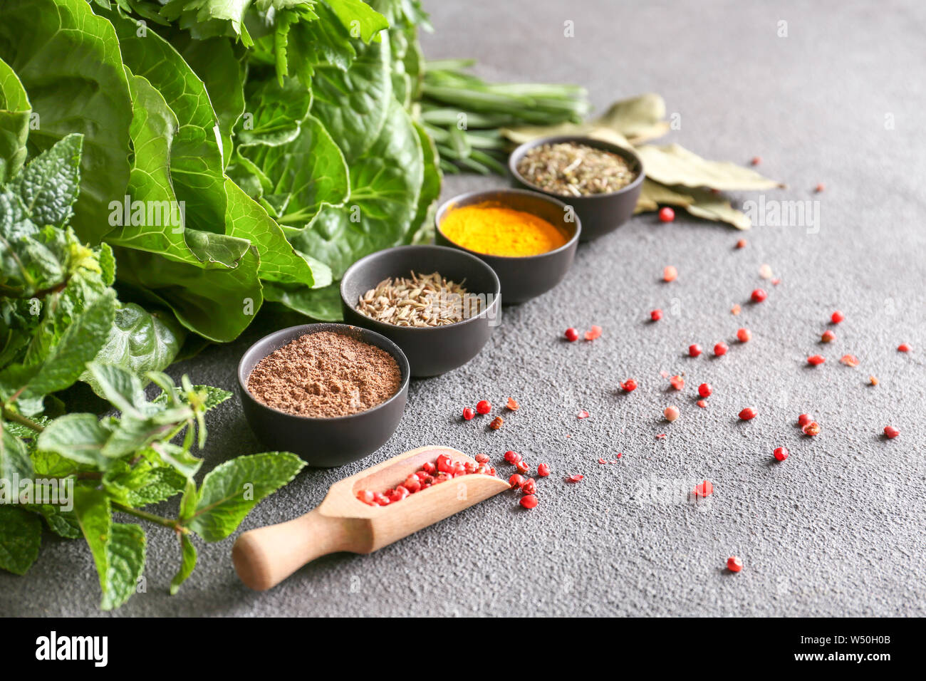 Different herbs and spices on grey background Stock Photo - Alamy