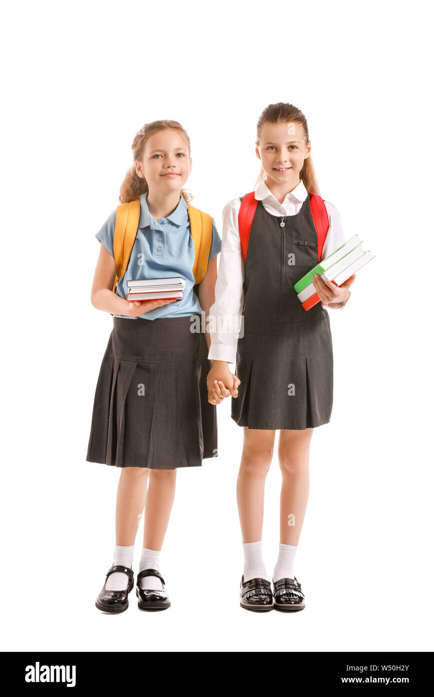 Cute little schoolgirls on white background Stock Photo - Alamy