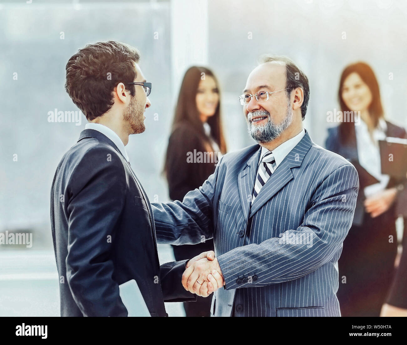 meeting of two business partners are shaking hands on a presentation in ...