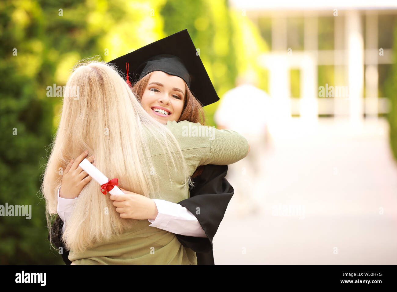 Happy mother greeting her daughter on graduation day Stock Photo - Alamy