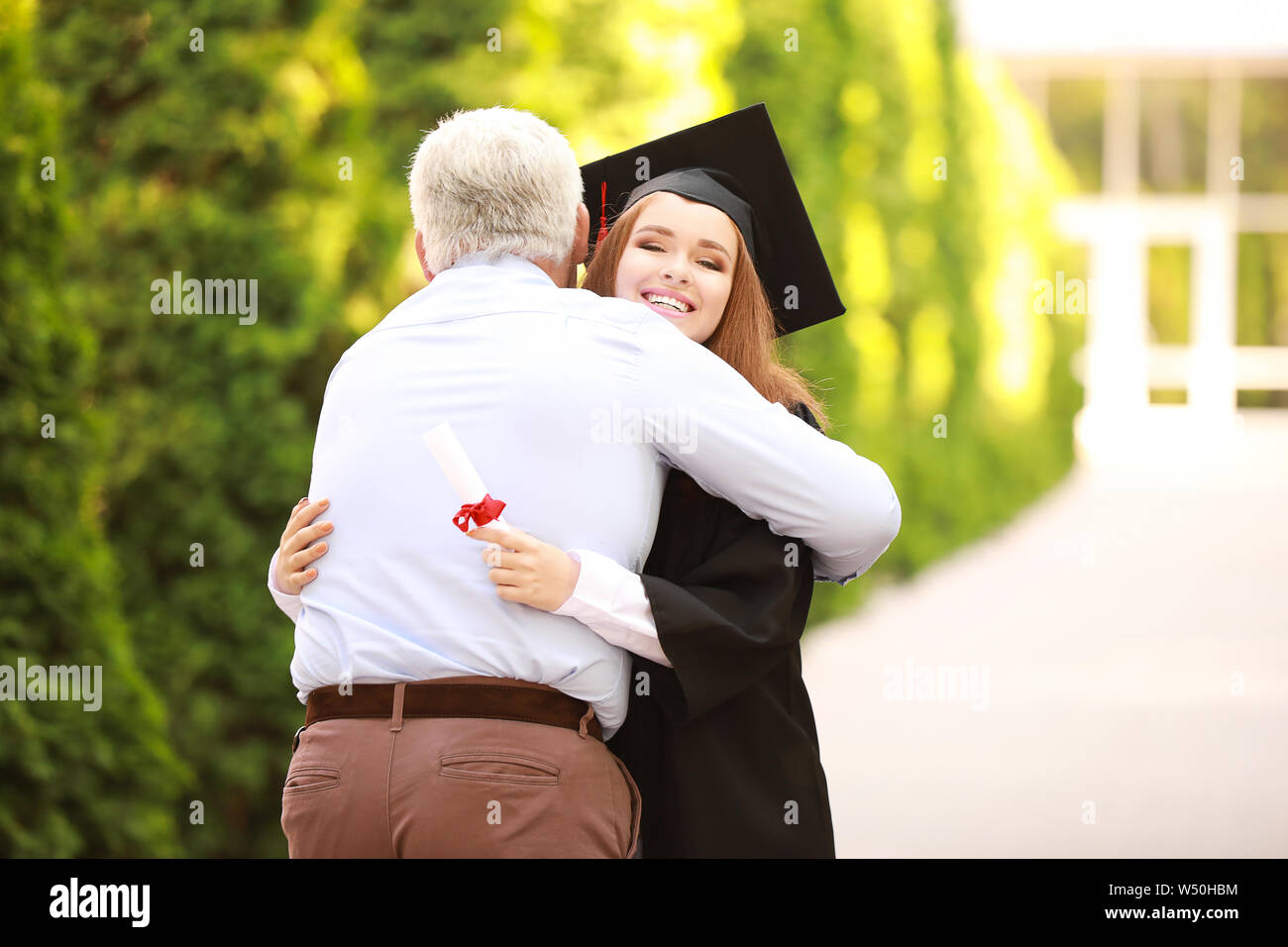 Father greeting his daughter on graduation day Stock Photo - Alamy