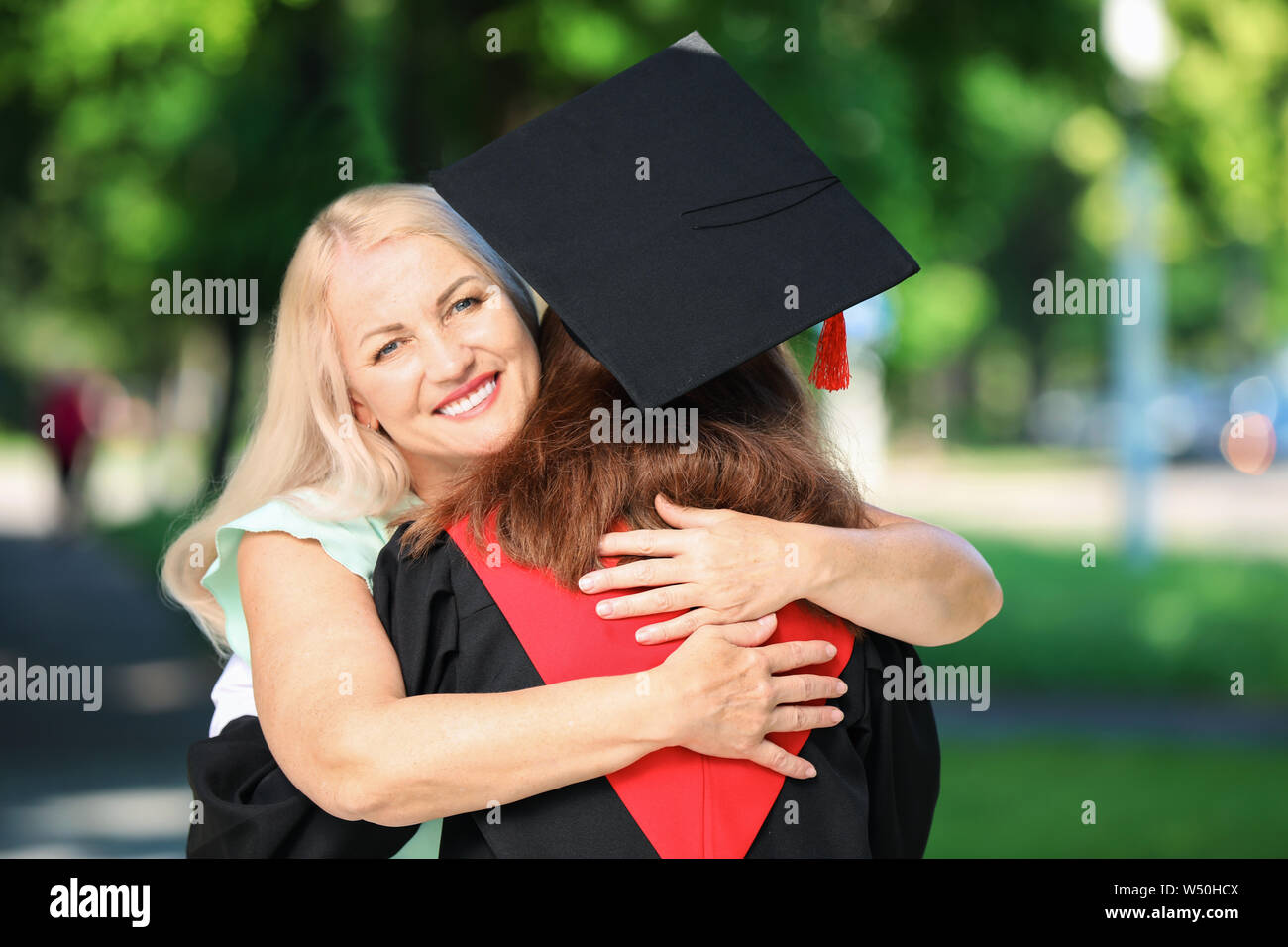 Happy mother greeting her daughter on graduation day Stock Photo - Alamy