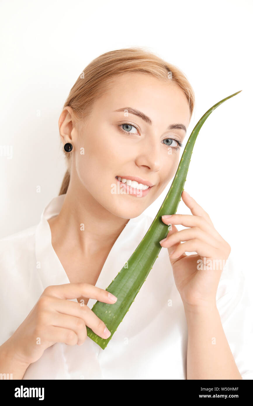 Beautiful young woman with aloe vera on white background Stock Photo ...