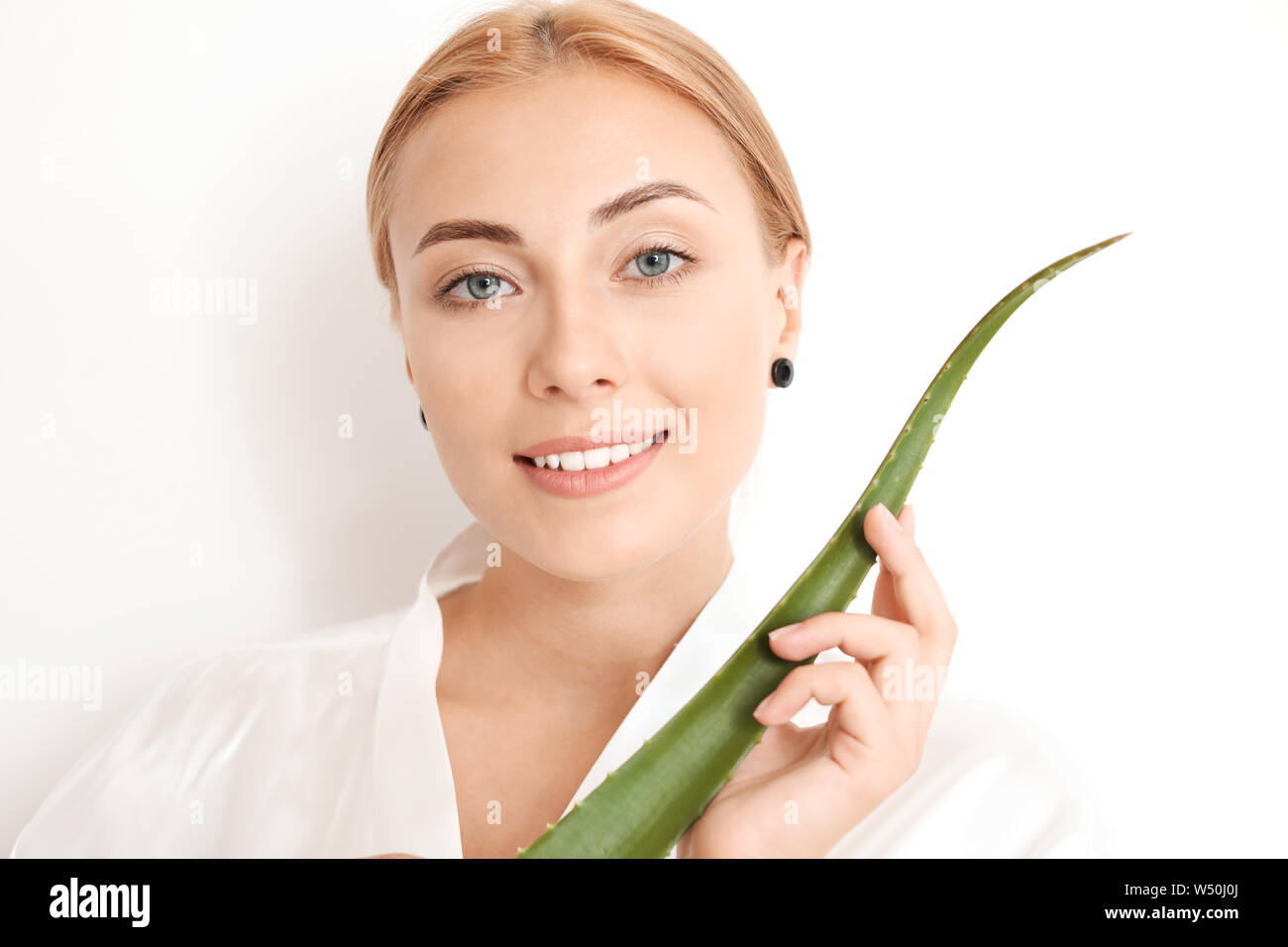Beautiful young woman with aloe vera on white background Stock Photo ...