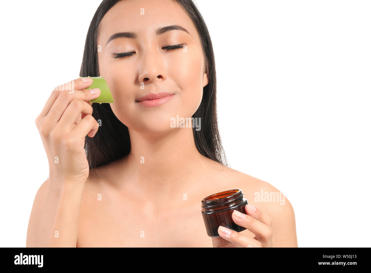 Beautiful Asian woman using cosmetics with aloe vera extract on white ...