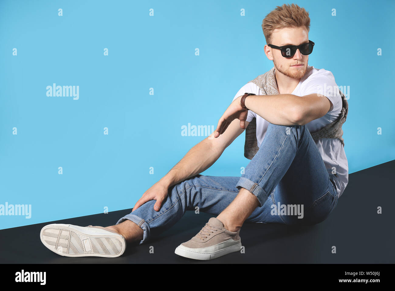 Stylish young man on color background Stock Photo - Alamy